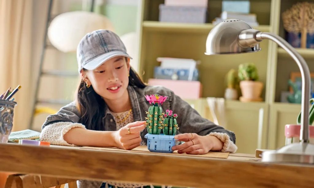 This set includes a pastel blue plant pot and two cactus. One of them ...